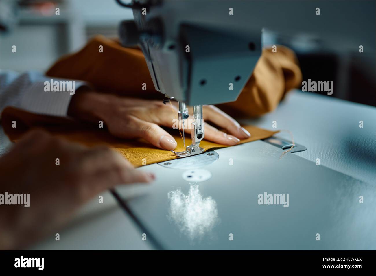 Tailor sews fabric on sewing hi-res stock photography and images - Alamy