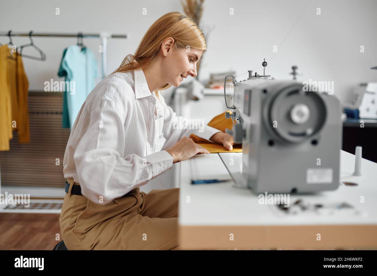 Woman sews cloth on sewing hi-res stock photography and images - Alamy