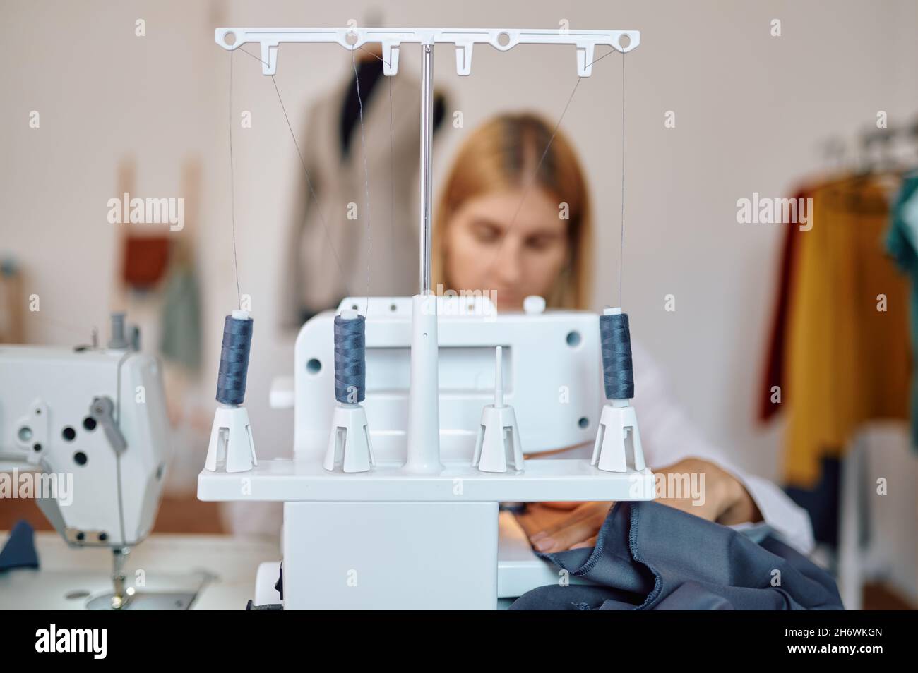 Dressmaker works on sewing machine at workplace Stock Photo - Alamy