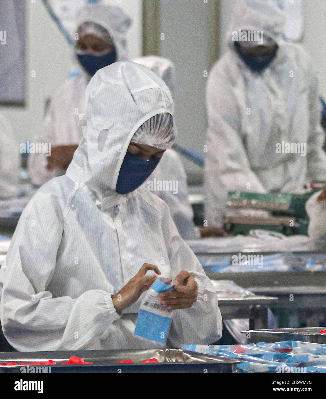 Employees wearing personal protective equipment work at Flexicare ...