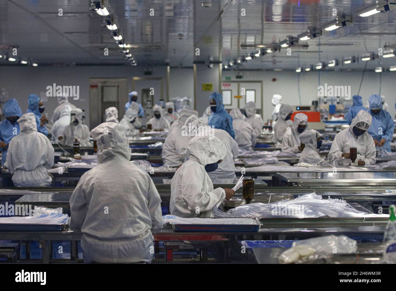 Employees wearing personal protective equipment work at Flexicare ...