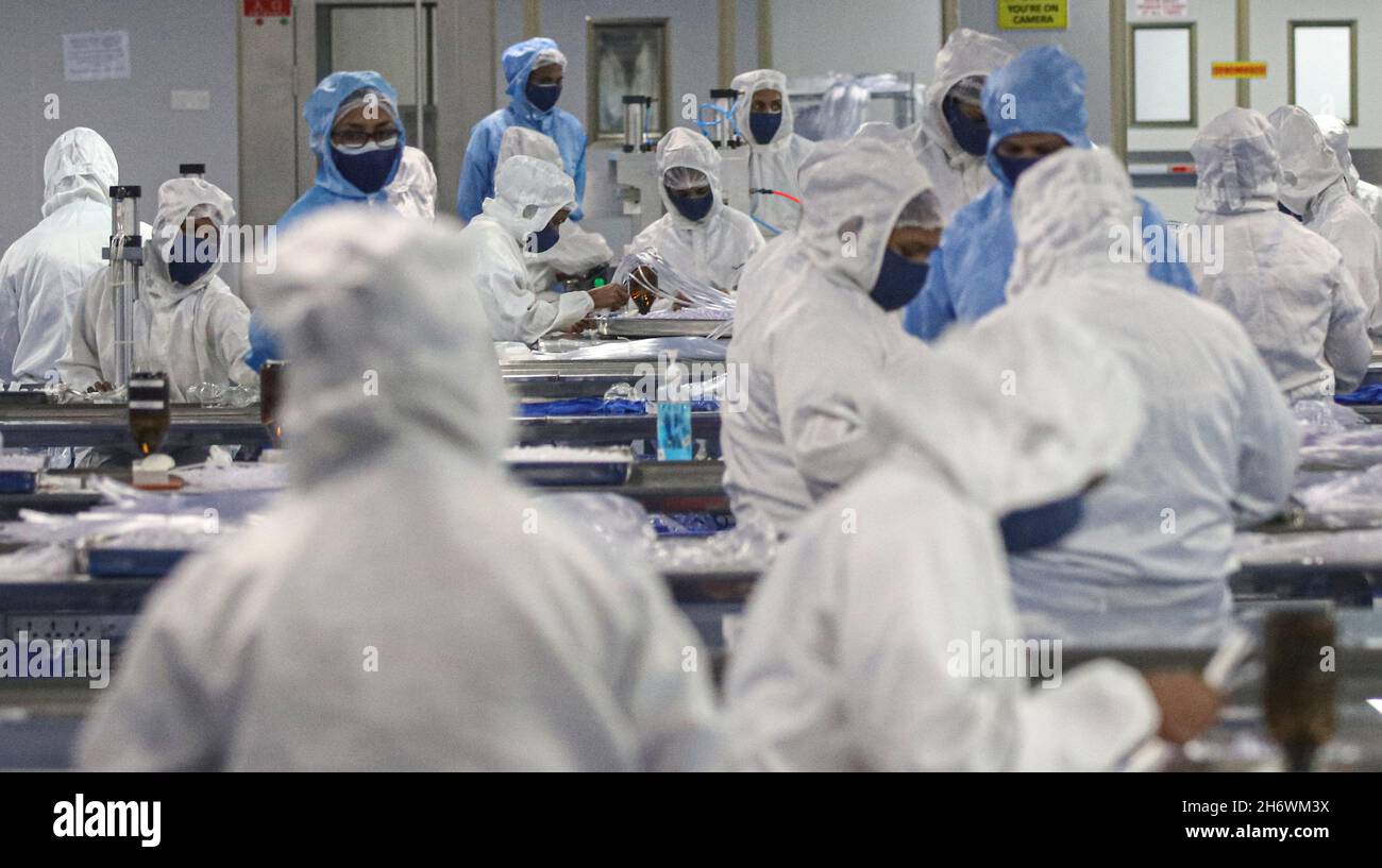 Employees wearing personal protective equipment work at Flexicare ...