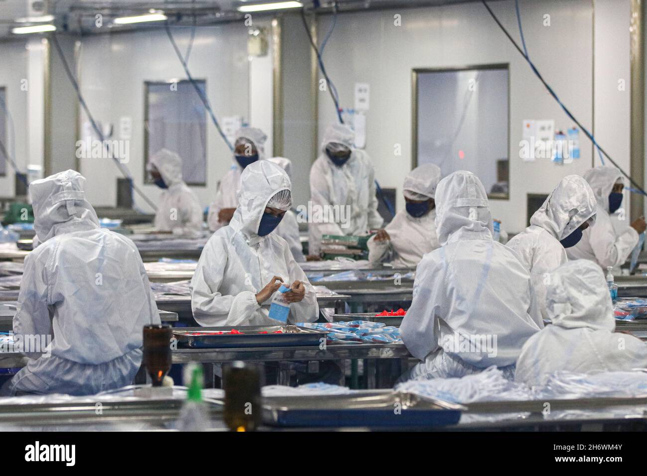 Employees wearing personal protective equipment work at Flexicare ...