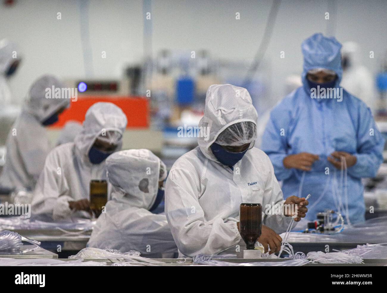 Employees wearing personal protective equipment work at Flexicare ...