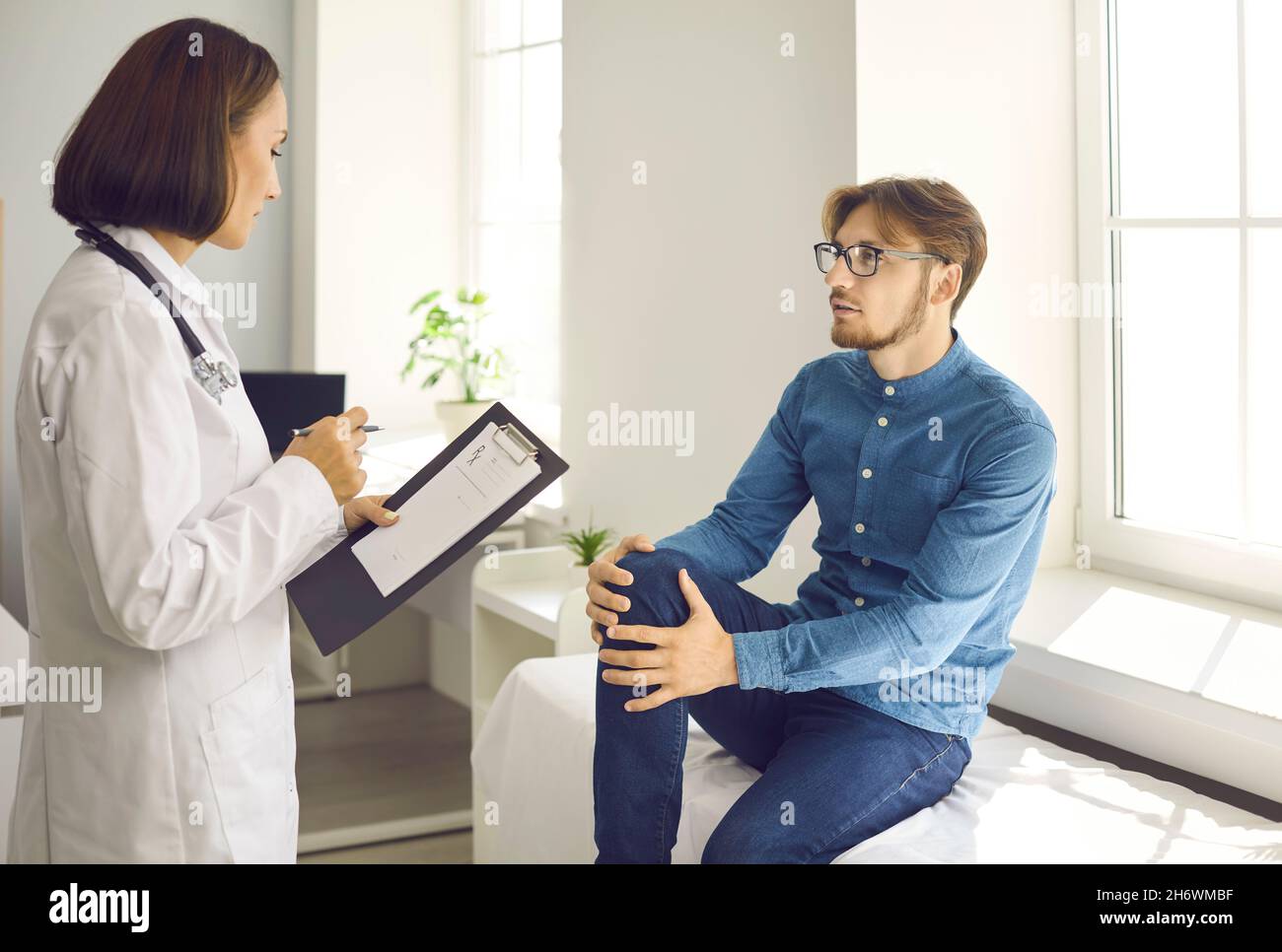 Female doctor consult male patient in hospital Stock Photo - Alamy