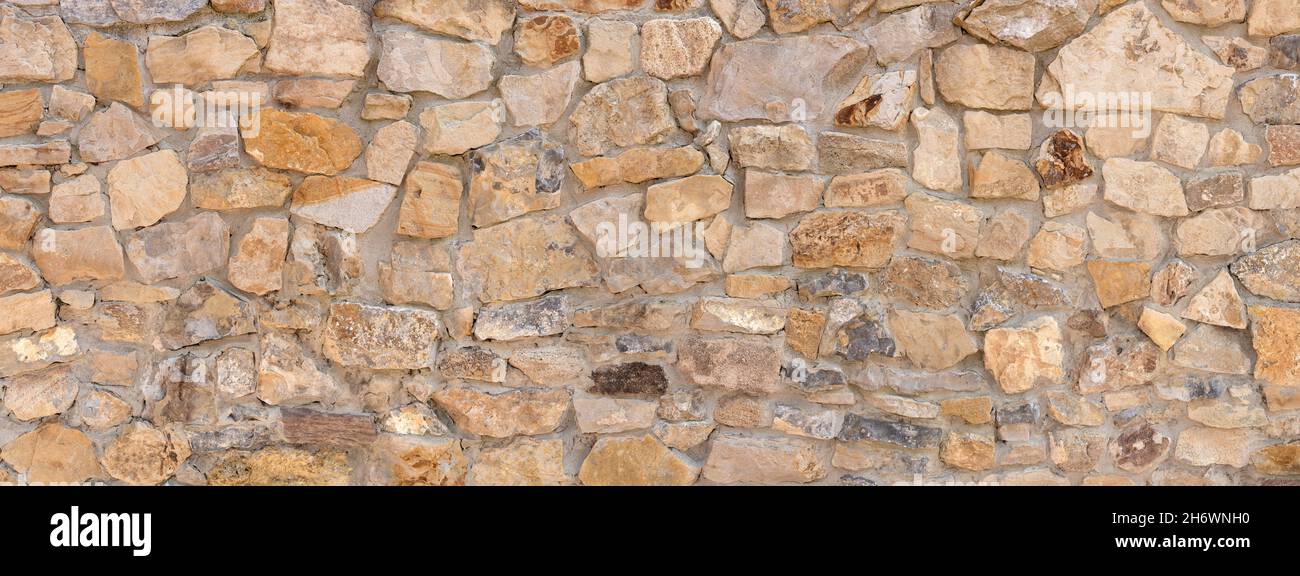 Coarse wall made of light brown natural stones in close-up Stock Photo ...