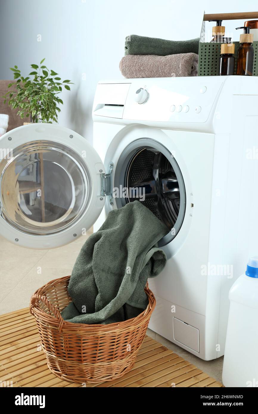 Concept of housework with washing machine against white wall Stock ...