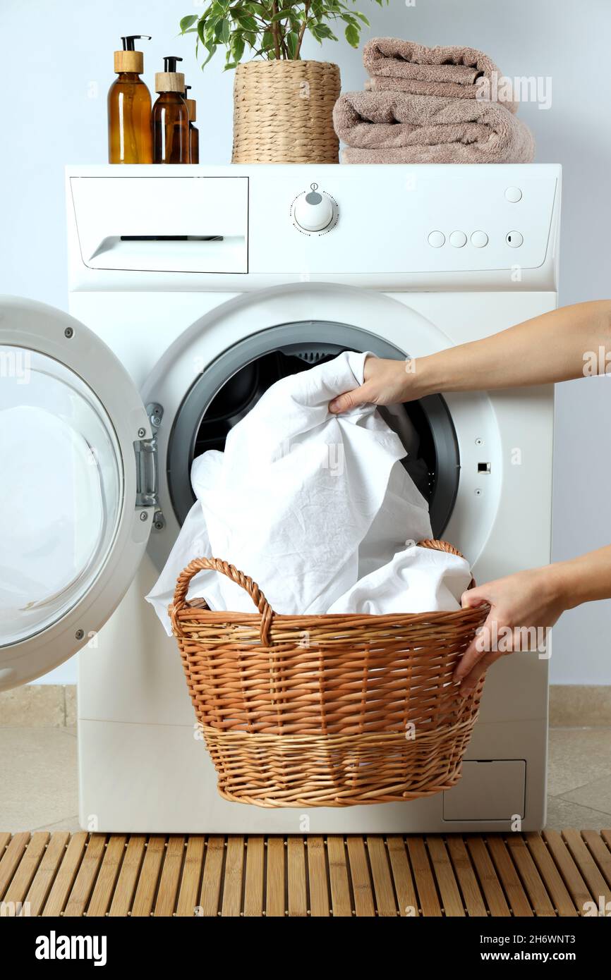 Concept of housework with washing machine against white wall Stock ...