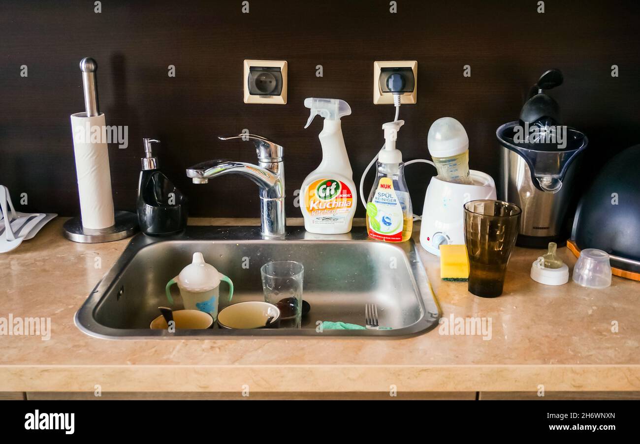 POZNAN, POLAND - May 02, 2015: A messy sink with cleaning products in a ...