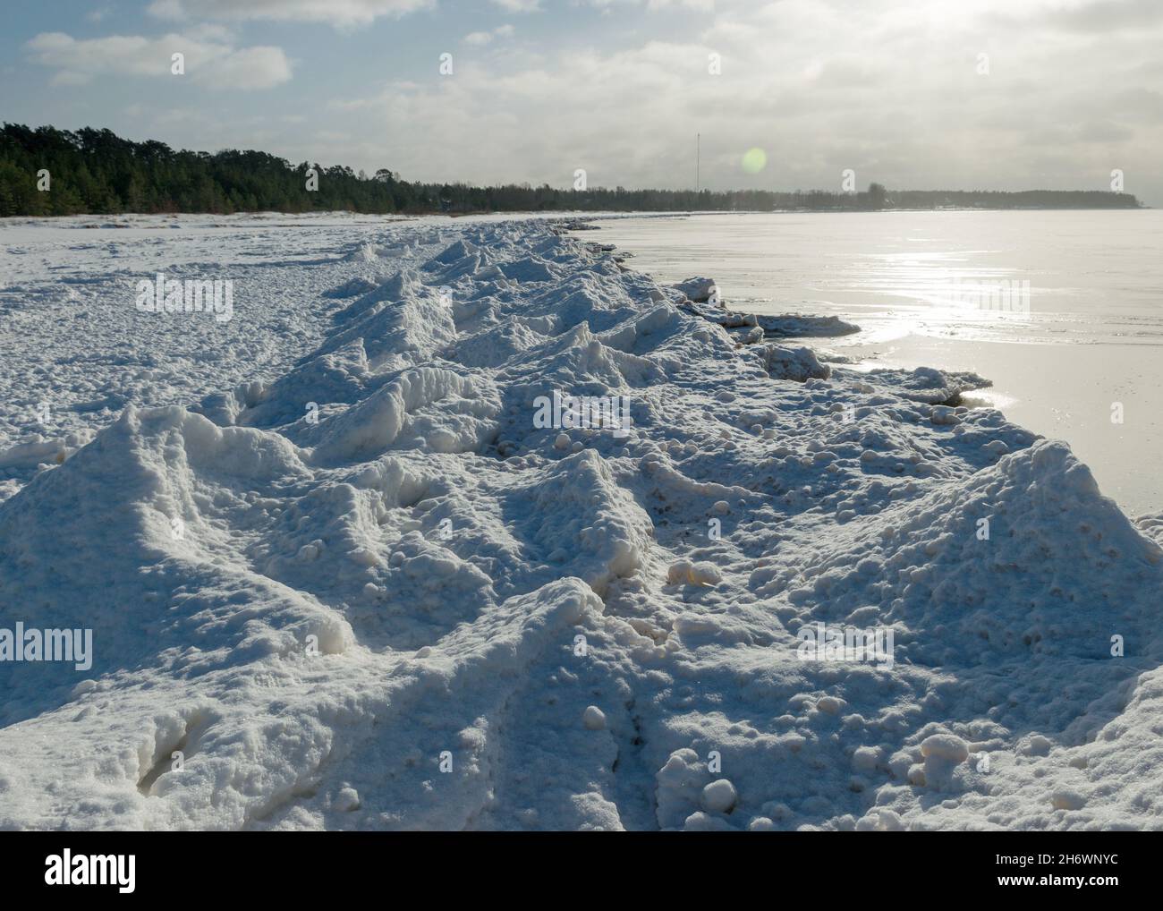 winter landscape by the sea, snowy pieces of ice by the sea, dunes ...