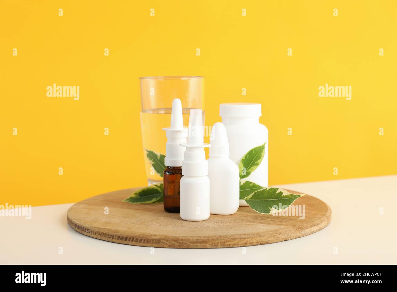 Tray with medicines against yellow background, seasonal cold treatment ...