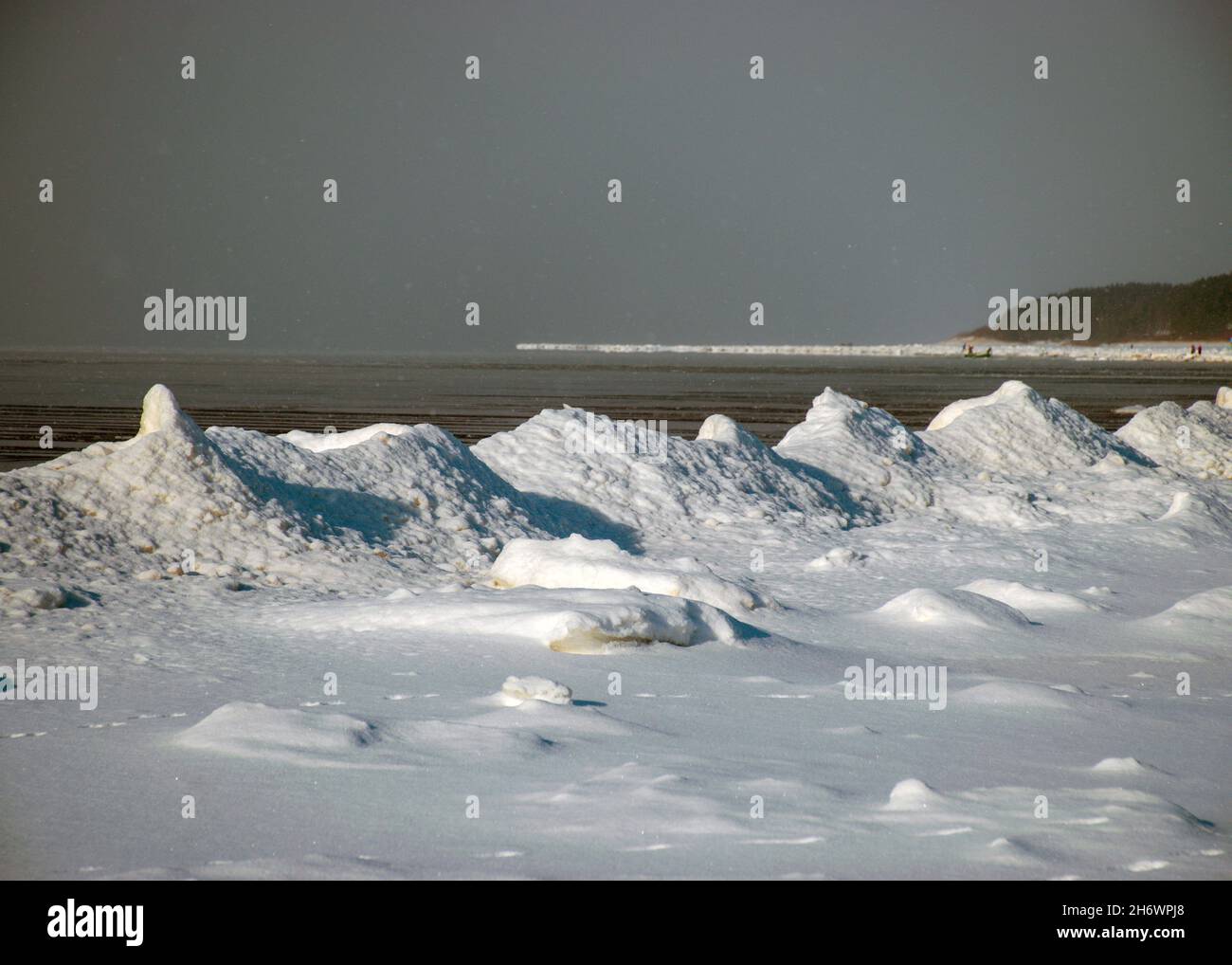 winter landscape by the sea, snowy pieces of ice by the sea, dunes ...
