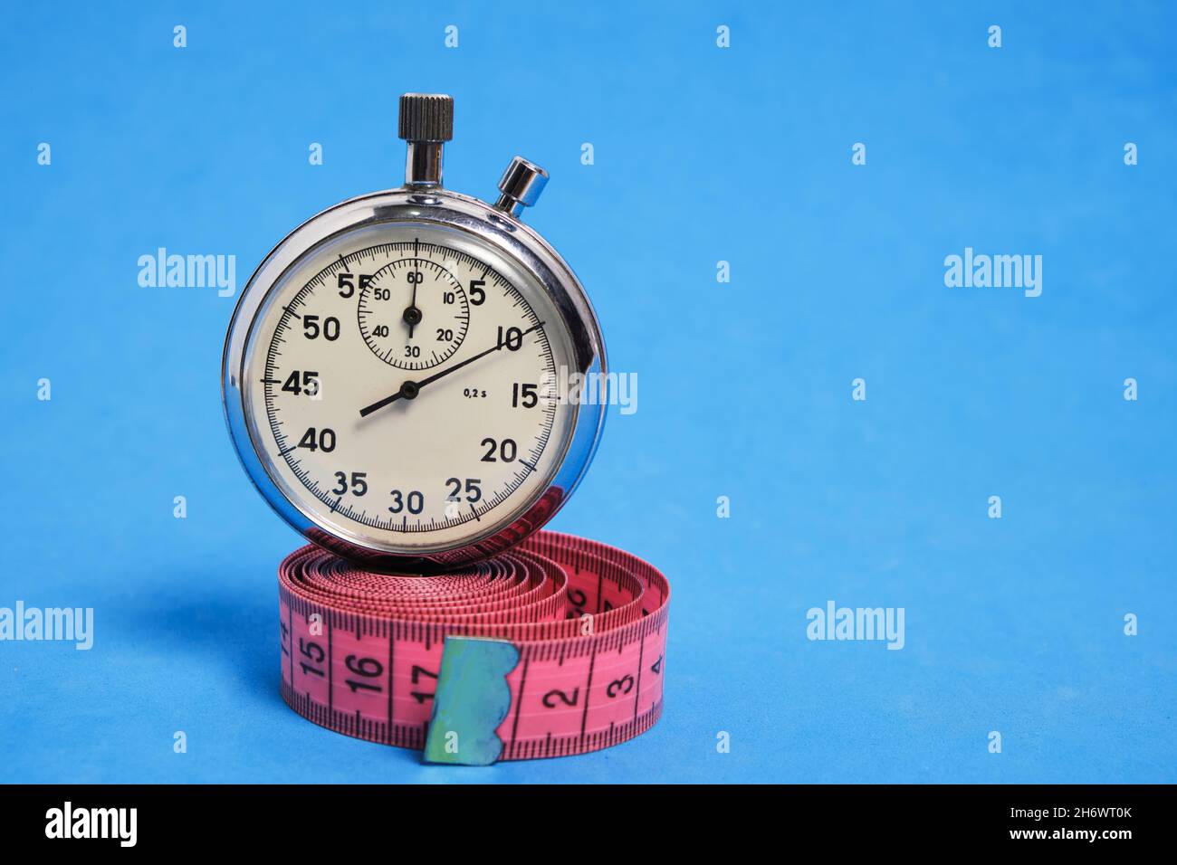 Stopwatch and measuring meter on blue background.Sports, health and ...