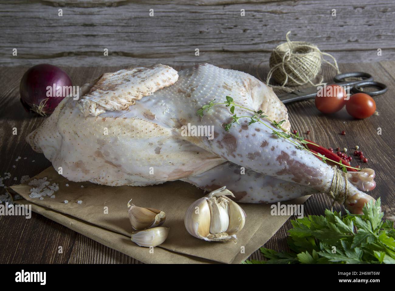 Fresh raw meat. A pale chicken carcass with seasonings and spices lies ...