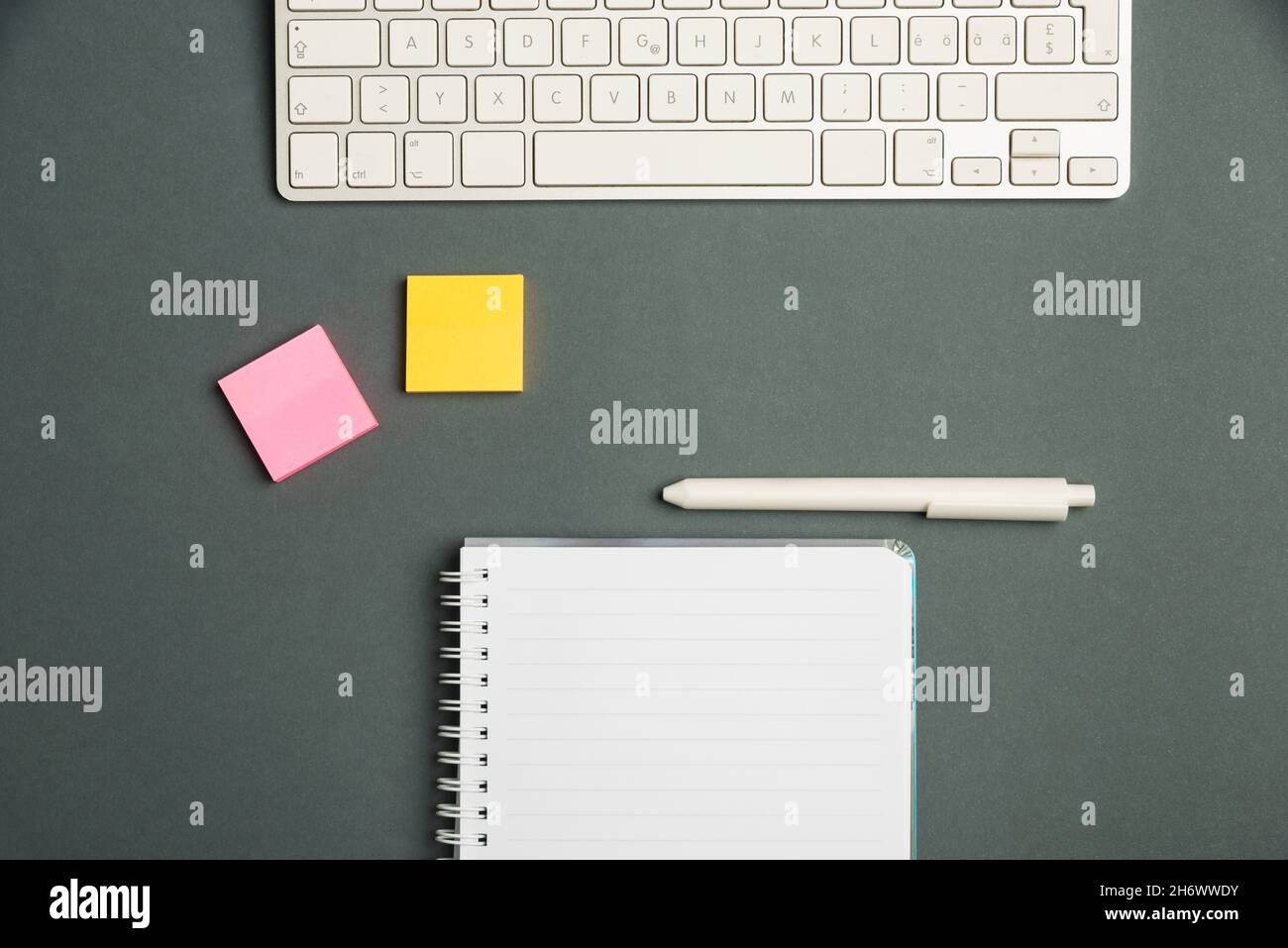 Keyboard Over A Table Beside A Notebook And Pens With Sticky Notes ...