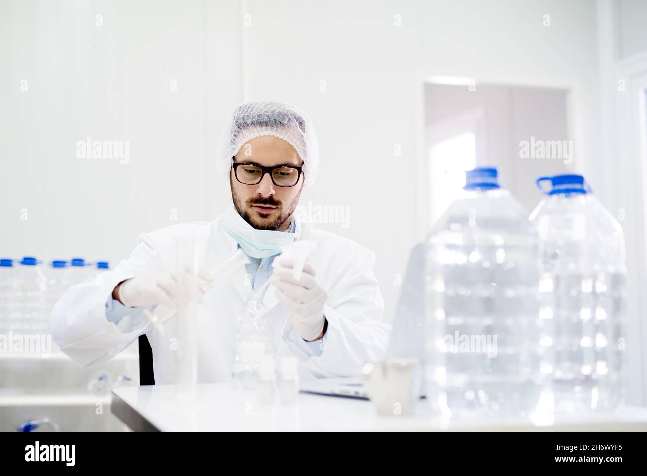 Plastic bottles production. Healthcare industry, scientist doing ...