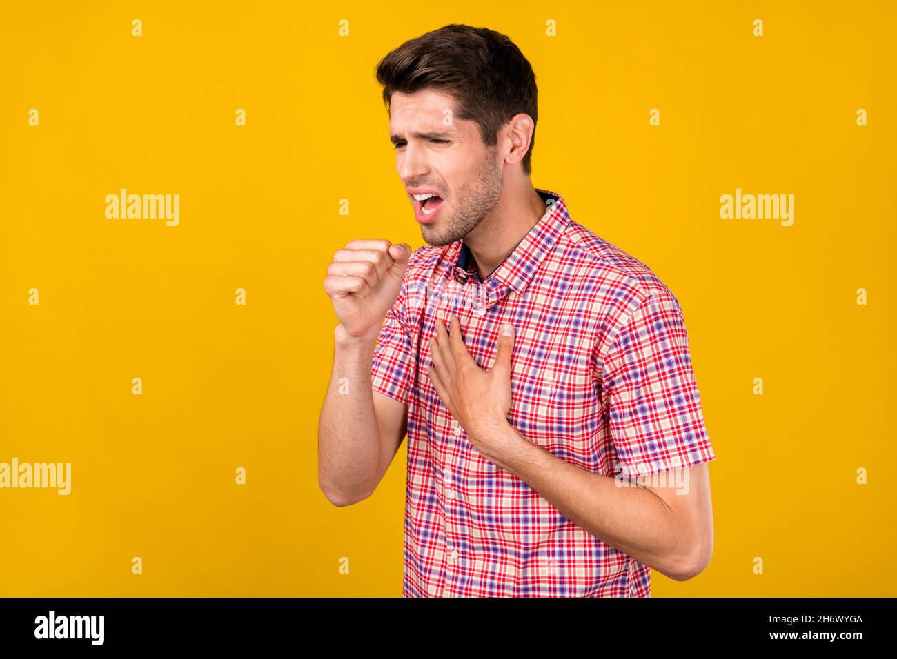 Profile side photo of young guy hands touch chest symptom coughing ...