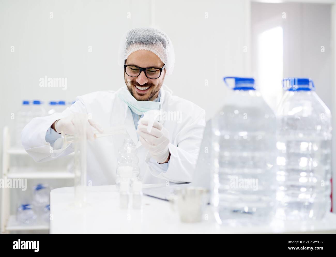 Happy lab scientist worker in glasses with laboratory pipettes Stock ...