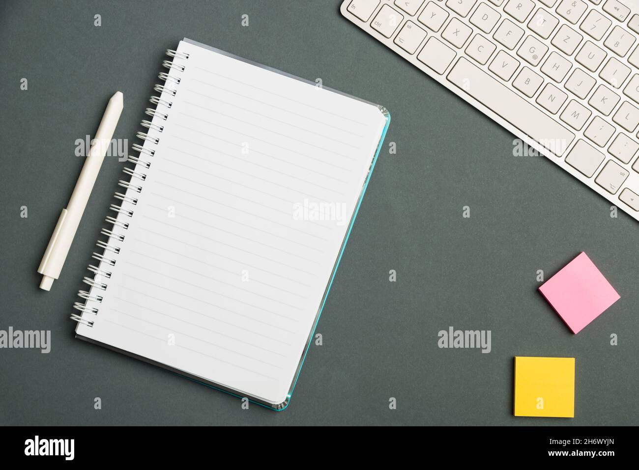 Keyboard Over A Table Beside A Notebook And Pens With Sticky Notes ...