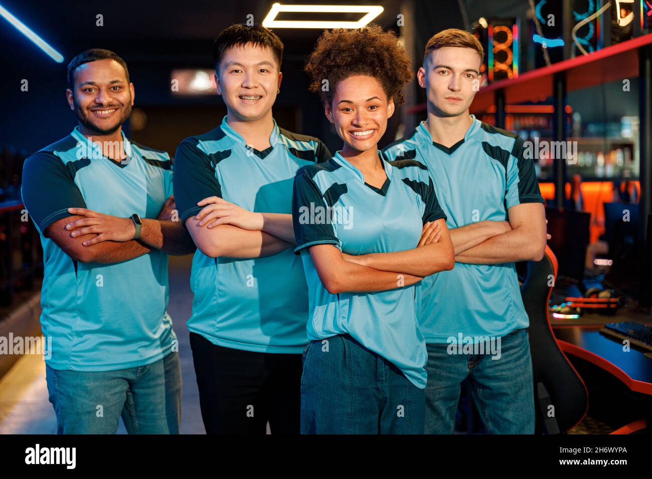 Professional team posing at camera in cyber club Stock Photo - Alamy