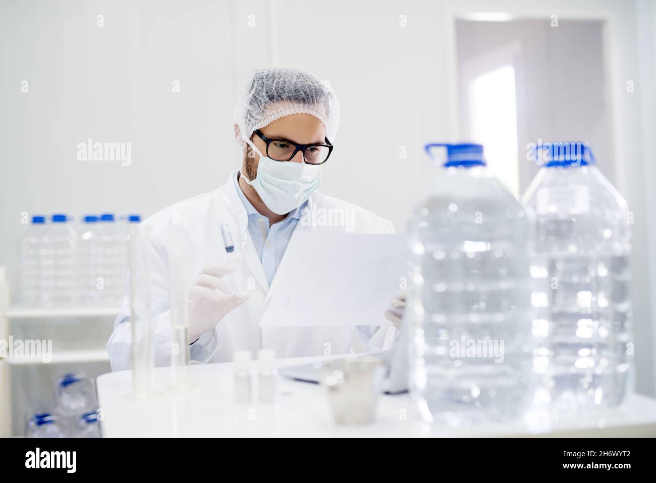 Plastic bottles production. Healthcare industry, scientist doing ...