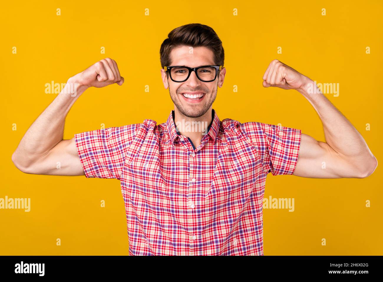 Photo of happy charming young man strong show flex muscles hands ...