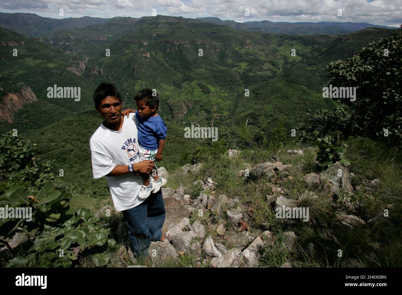 Father & child walk through a small Huichol town. The Huichol are one ...