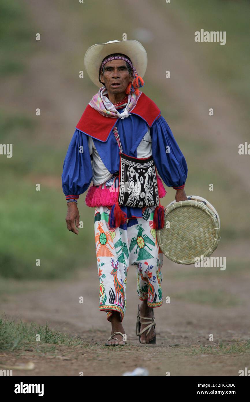 A man walks through a small Huichol town. The Huichol are one of the ...