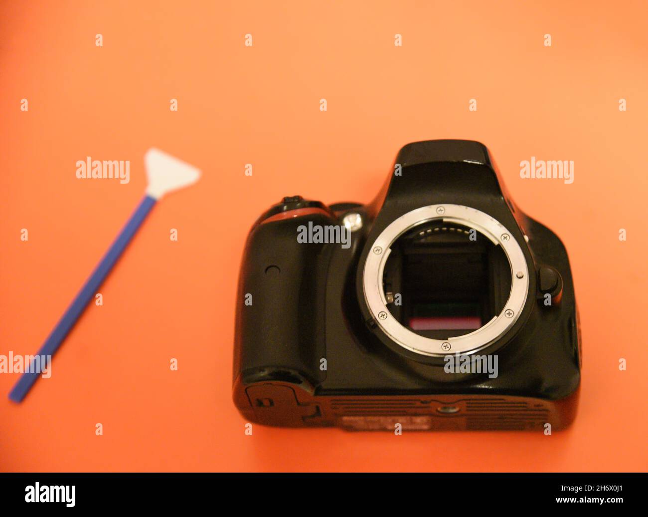 Photographer cleaning photocamera light sensor. Cleaning matrix SLR ...