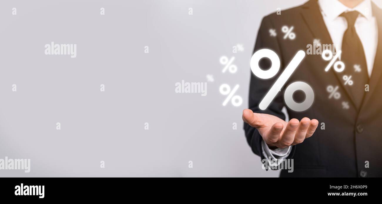 Male hand holding interest rate percent icon on blue background ...