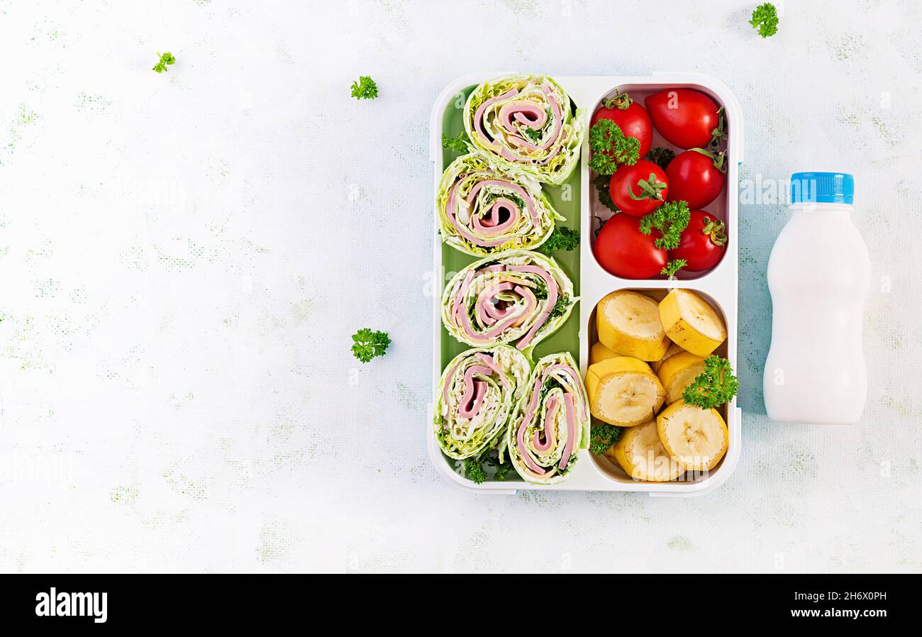 School lunchbox. Healthy lunch box with tortilla wraps, tomatoes ...