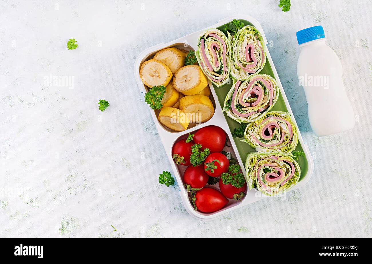 School lunchbox. Healthy lunch box with tortilla wraps, tomatoes ...