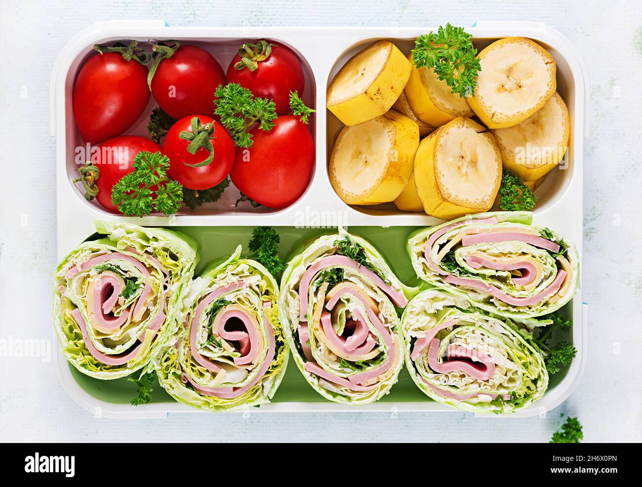 School lunchbox. Healthy lunch box with tortilla wraps, tomatoes and ...