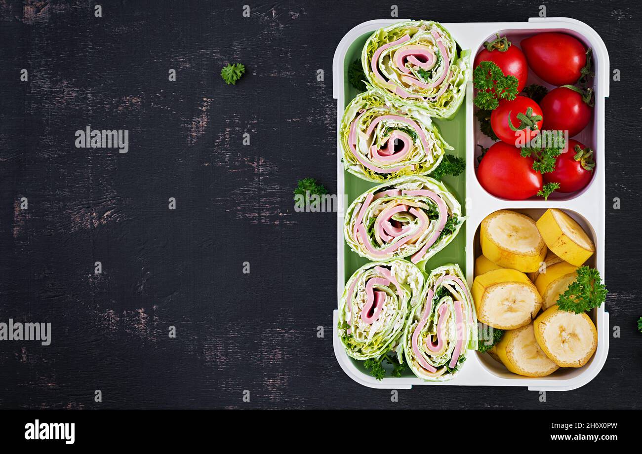School lunchbox. Healthy lunch box with tortilla wraps, tomatoes ...
