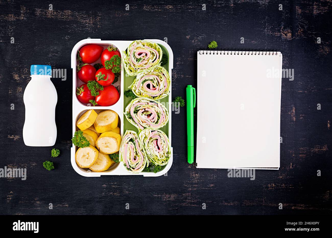 School lunchbox. Healthy lunch box with tortilla wraps, tomatoes ...
