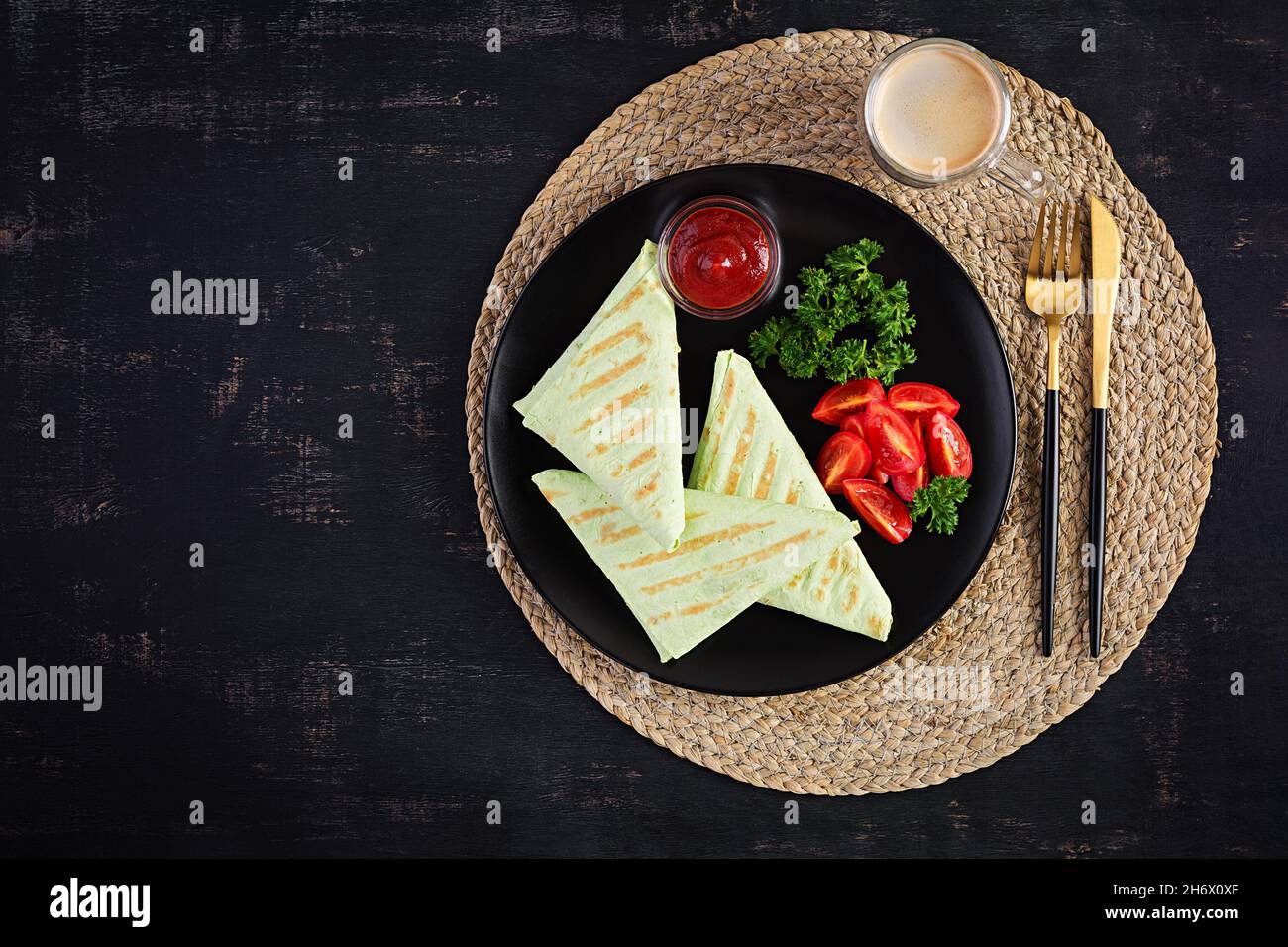 Homemade flatbread with cheese, tomatoes and green herbs. Traditional ...