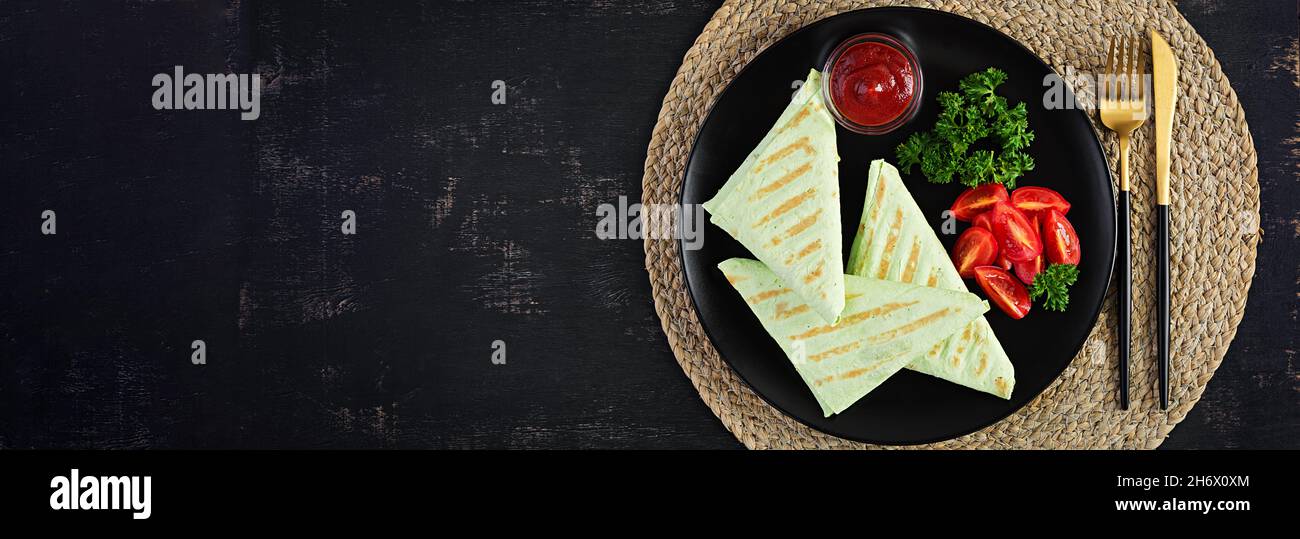 Homemade flatbread with cheese, tomatoes and green herbs. Traditional ...