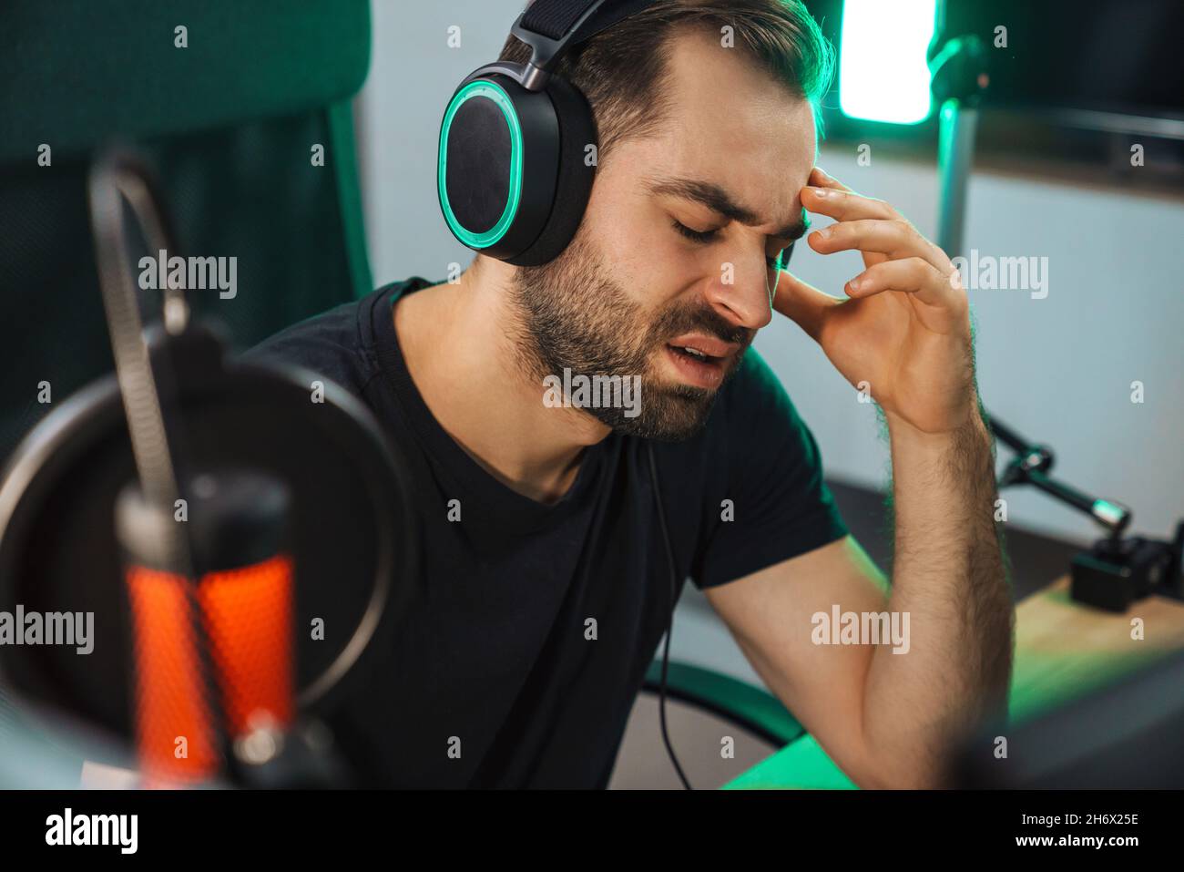 Angry devastated young man gamer wearing headphones lost a game on ...
