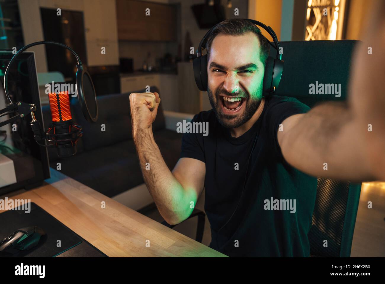 Happy young man taking selfie photo while playing video game on ...