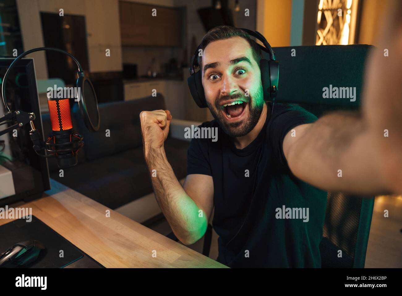 Happy young man taking selfie photo while playing video game on ...