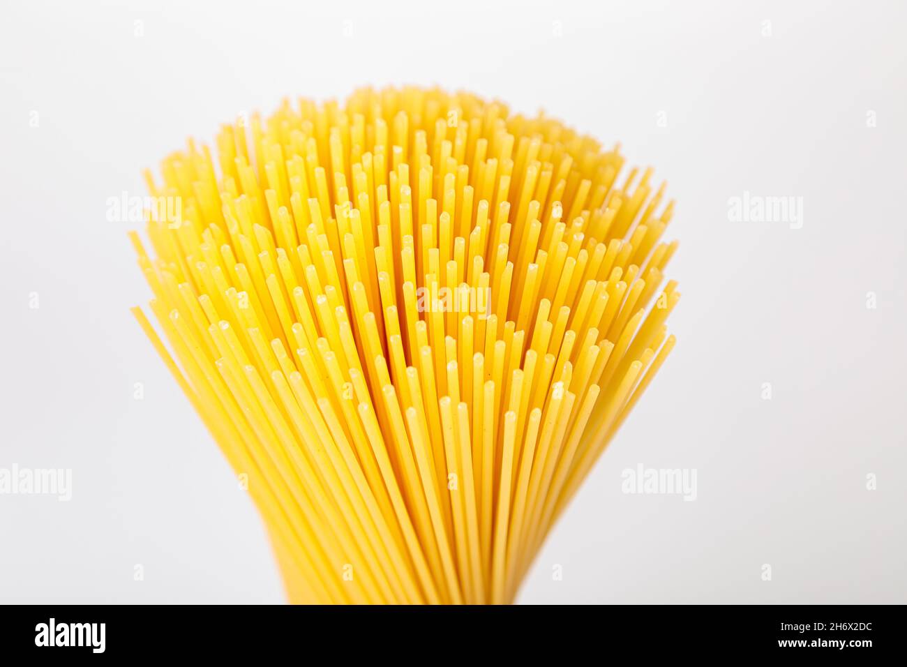 An upright bunch, a bunch of raw spaghetti tied with rope. Bundle on a ...