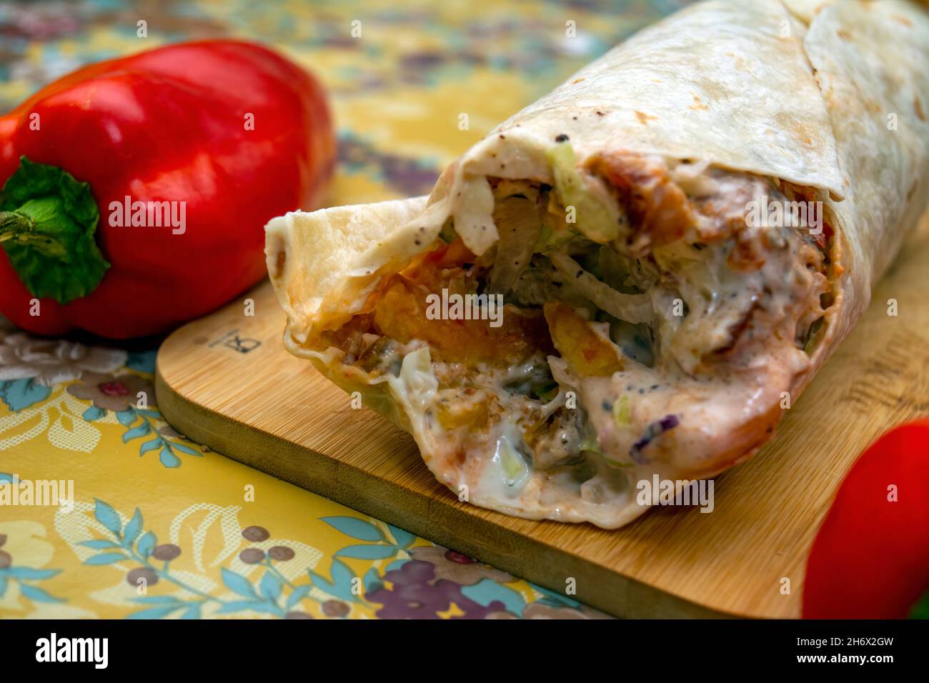 Juicy delicious shaorma with vegetables and garlic sauce made in a ...