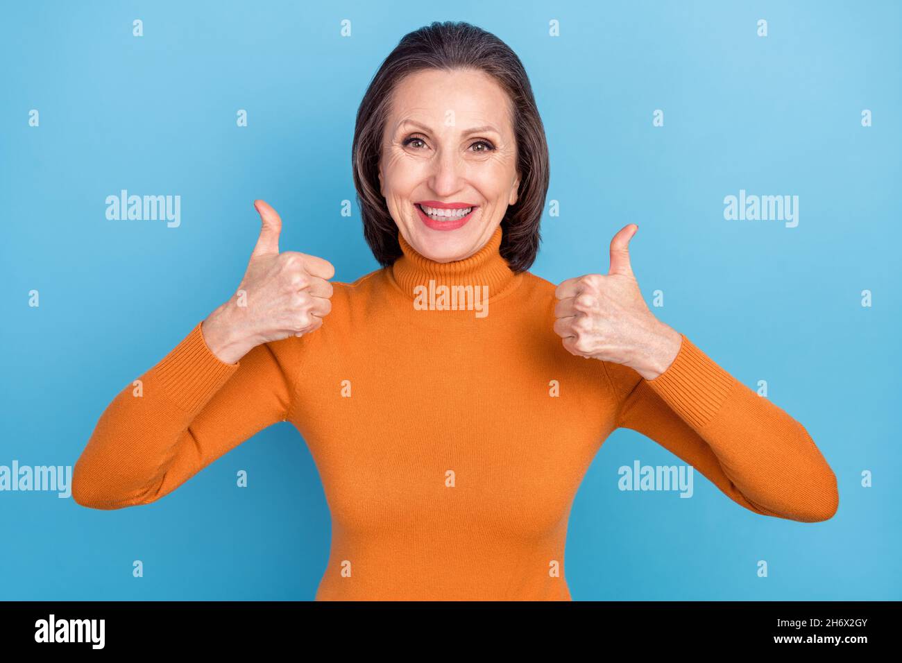 Photo of cheerful pretty lady two hands show thumbs up beaming smile ...