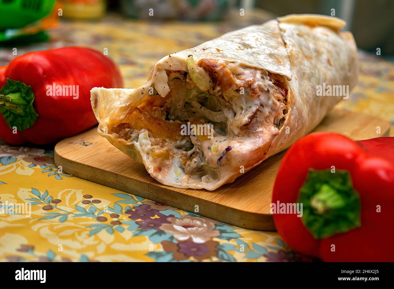 Juicy delicious shaorma with vegetables and garlic sauce made in a ...