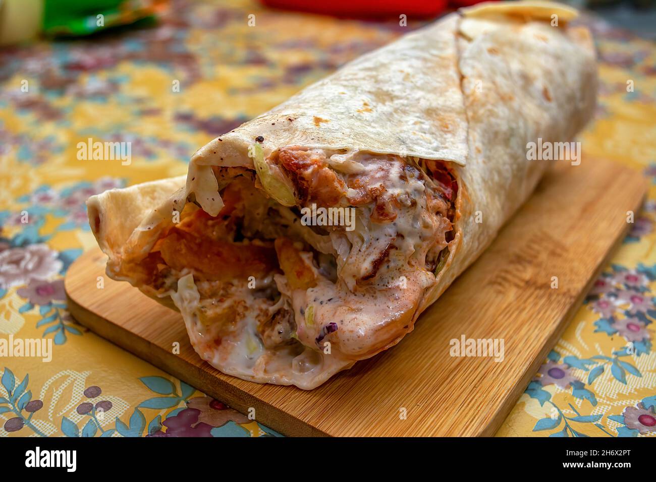 Juicy delicious shaorma with vegetables and garlic sauce made in a ...