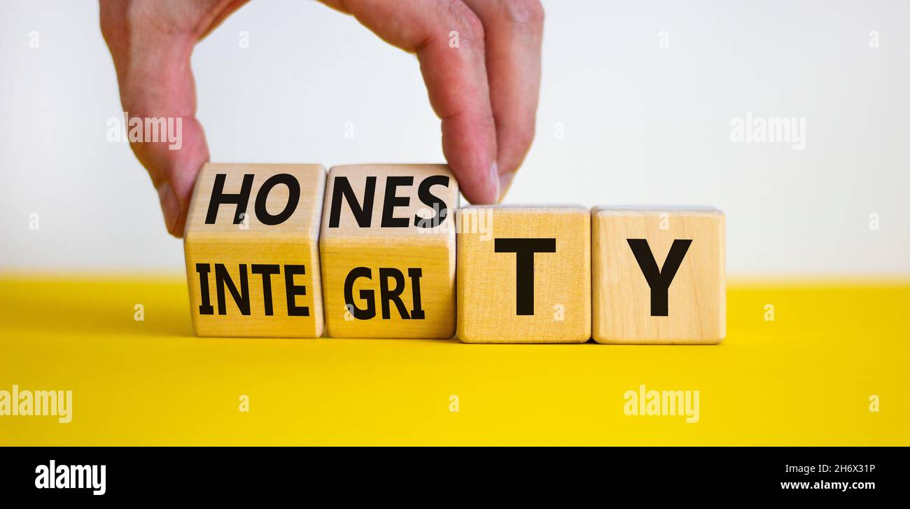Honesty and integrity symbol. Businessman turns wooden cubes and ...