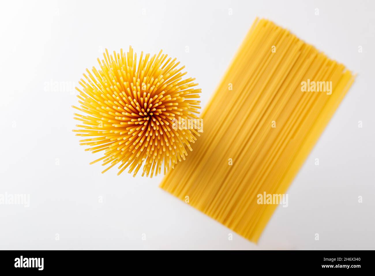 A vertical bunch and a bunch of raw spaghetti tied with string. Bundle ...