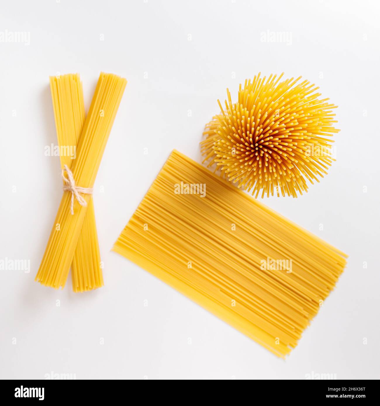 A vertical bunch and a bunch of raw spaghetti tied with string. Bundle ...
