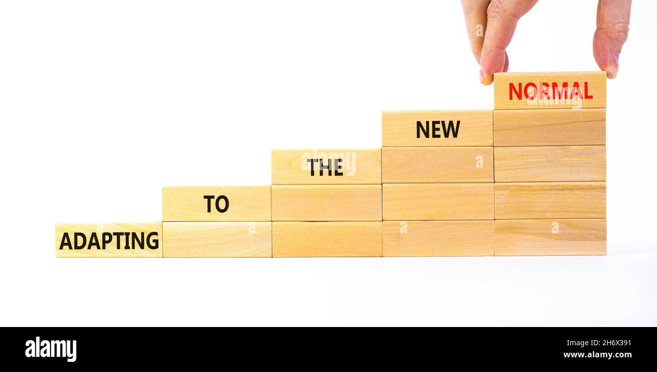 Adapting to the new normal symbol. Wooden blocks with words Adapting to ...