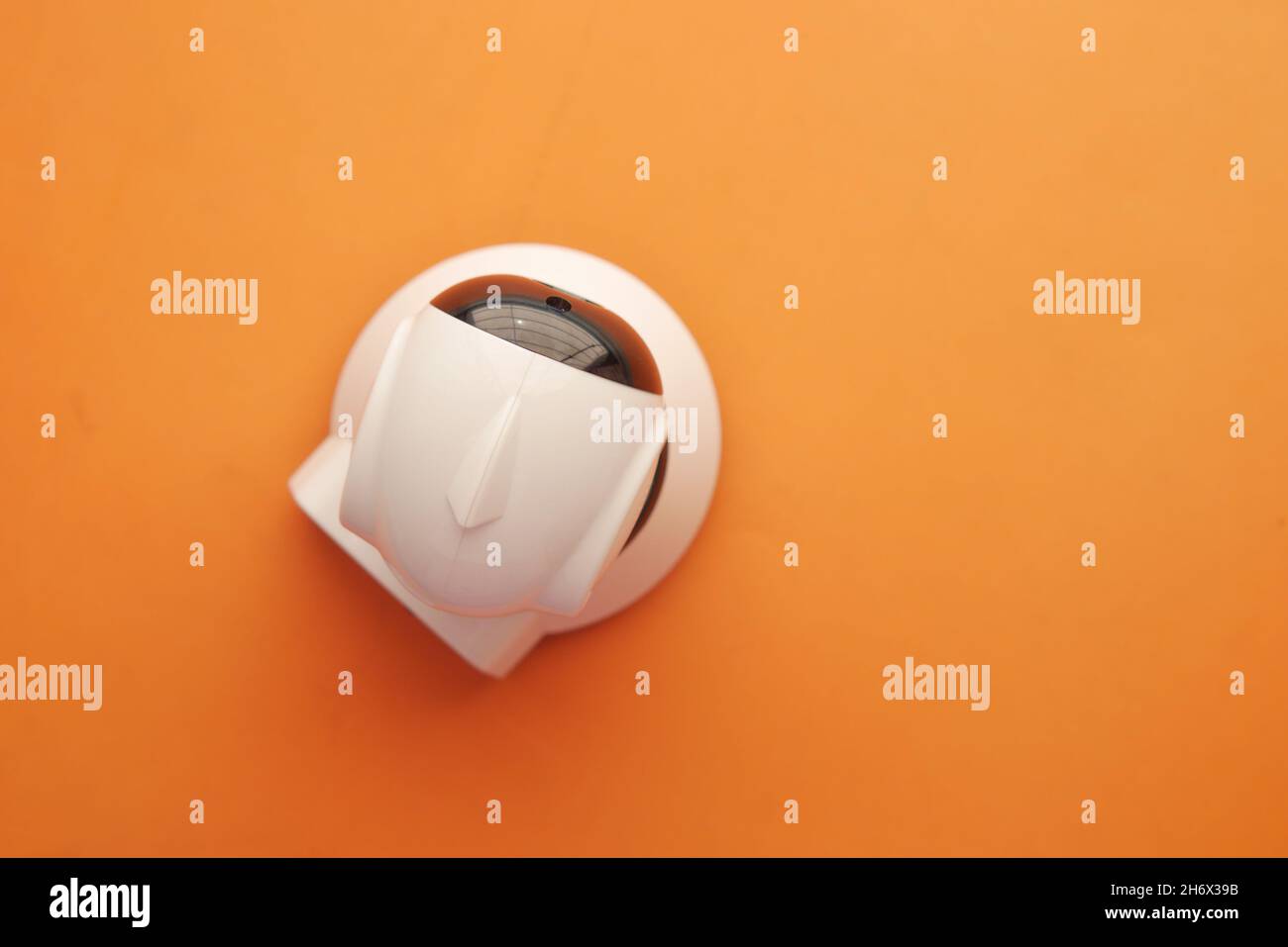 CCTV security camera operating on light orange background Stock Photo ...